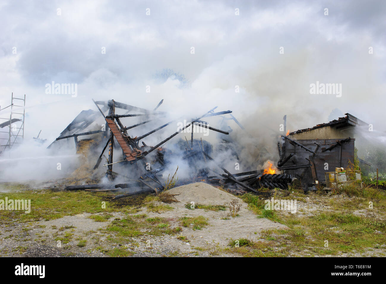 Firefighter in action at burning farm house in Germany Stock Photo - Alamy