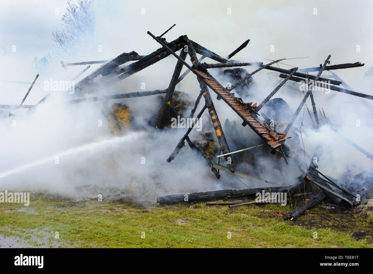 Firefighter in action at burning farm house in Germany Stock Photo - Alamy