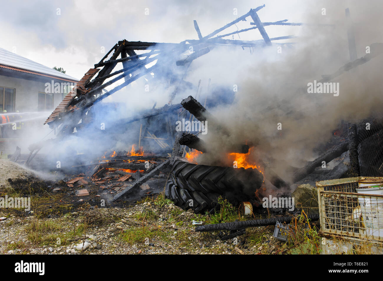 Firefighter in action at burning farm house in Germany Stock Photo - Alamy