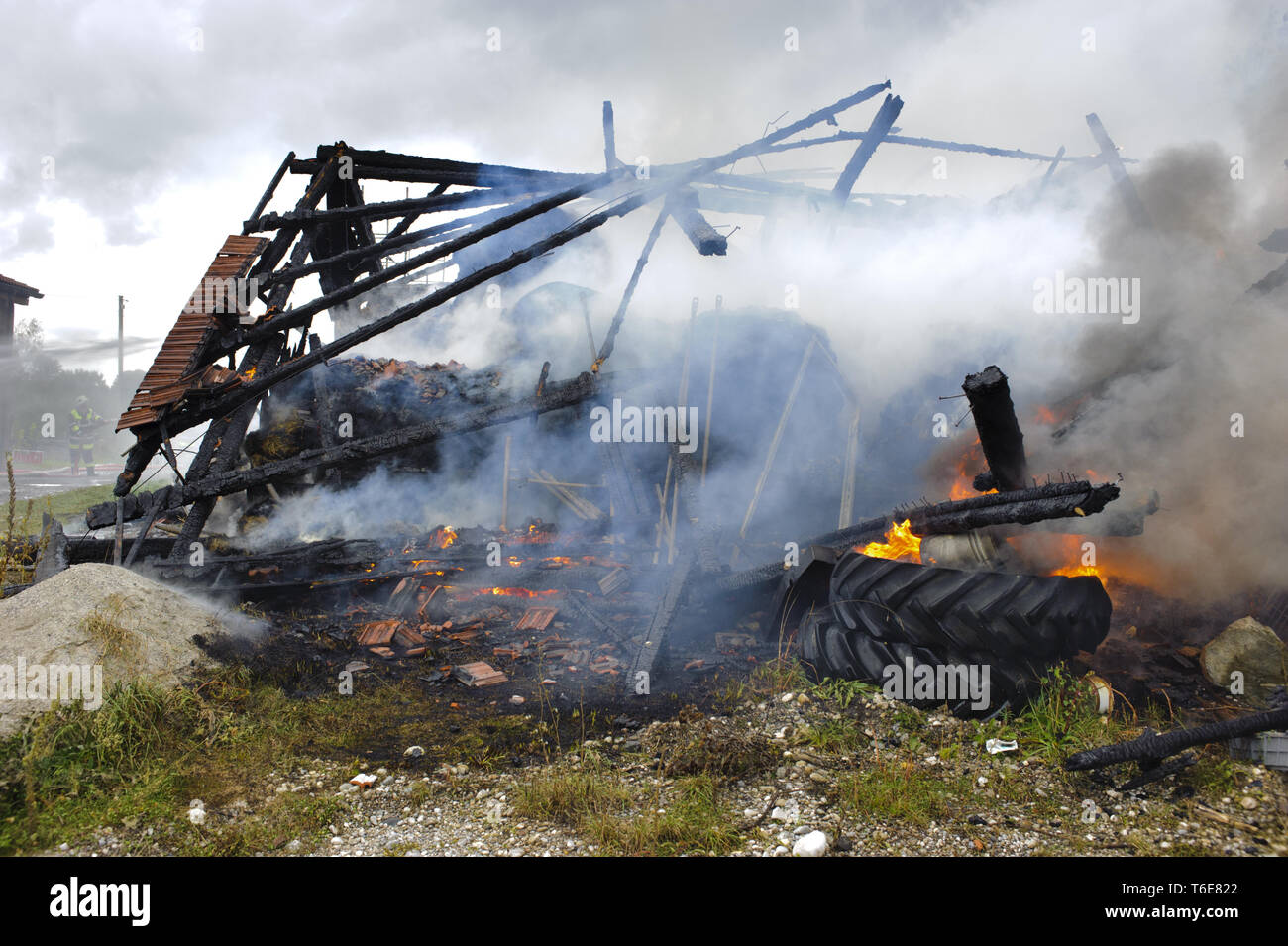 Firefighter in action at burning farm house in Germany Stock Photo - Alamy