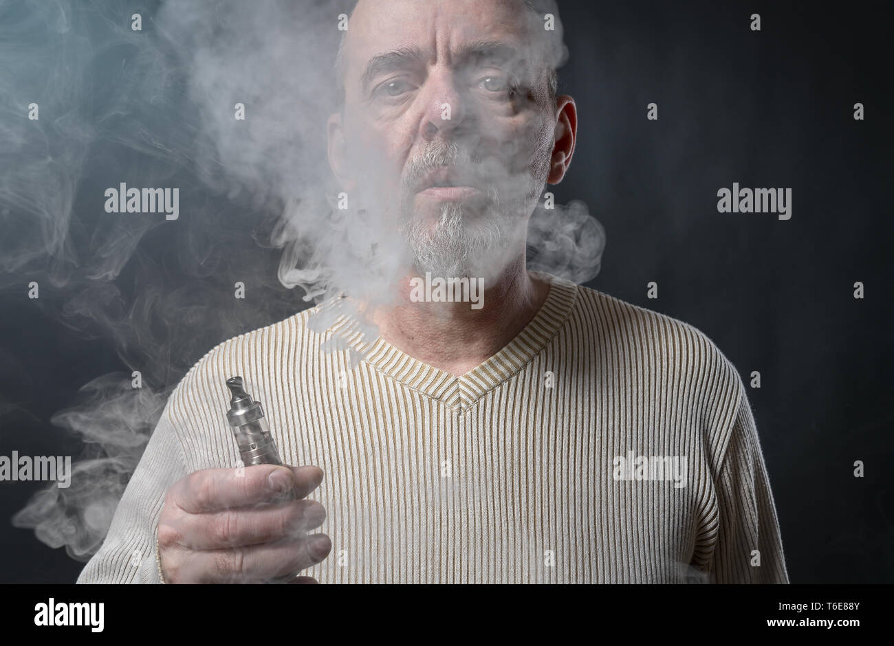 Portrait of a man with beard who is vaping Stock Photo - Alamy