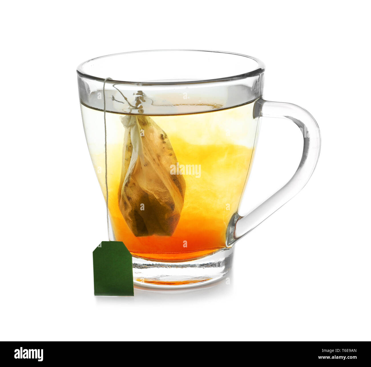Brewing of hot tea in glass cup on white background Stock Photo - Alamy