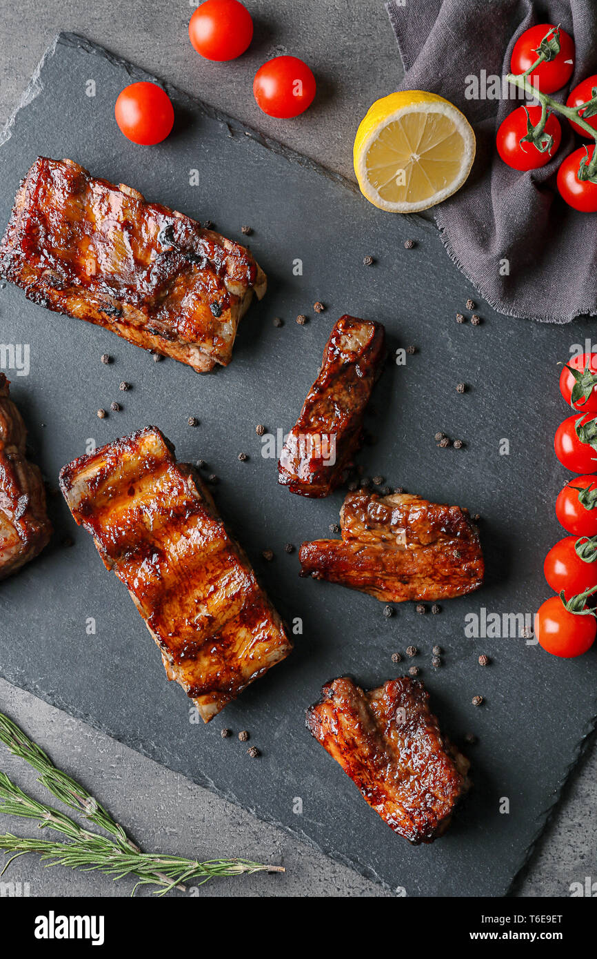 Delicious grilled ribs with spices on slate plate Stock Photo - Alamy