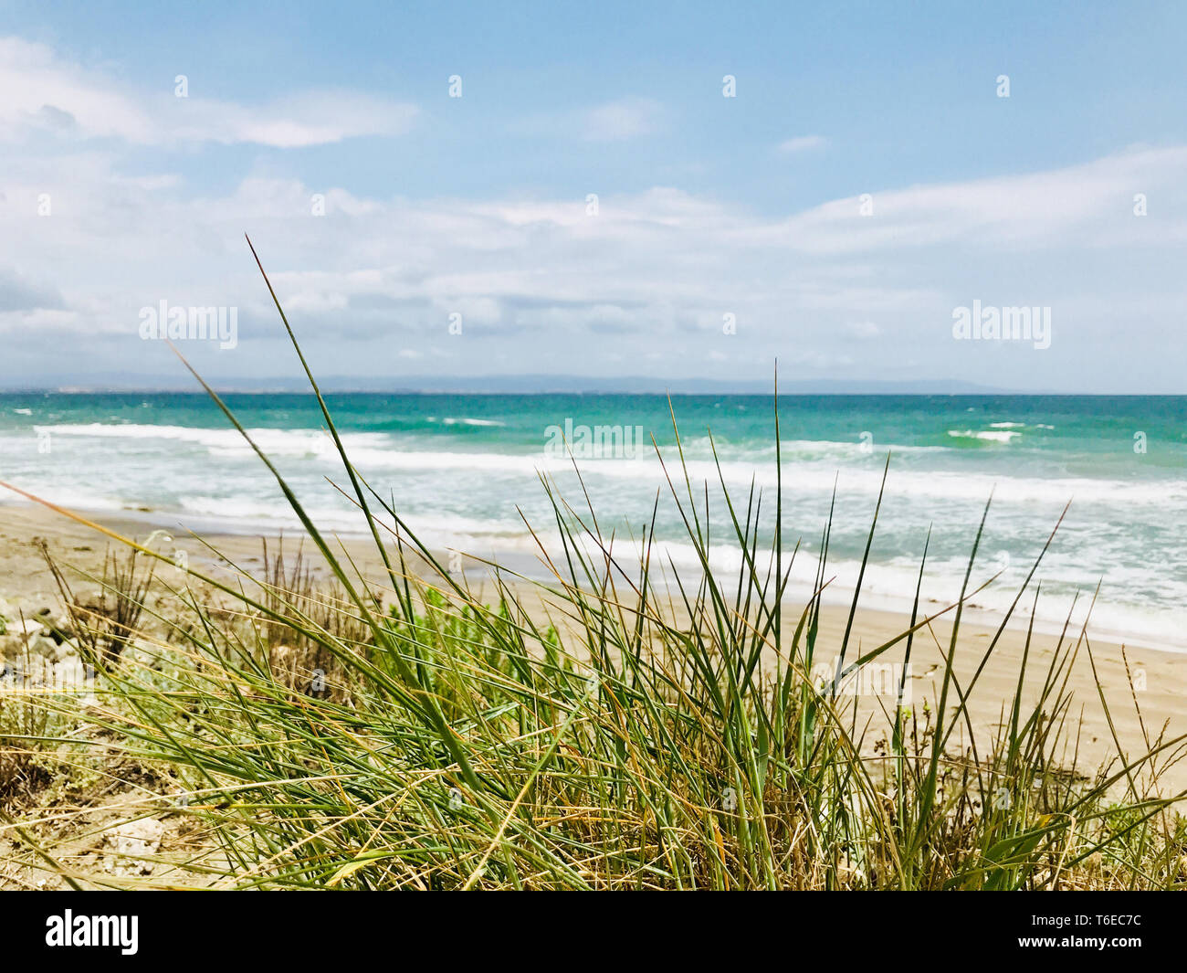 Beach and sea in bright sunlight Stock Photo - Alamy