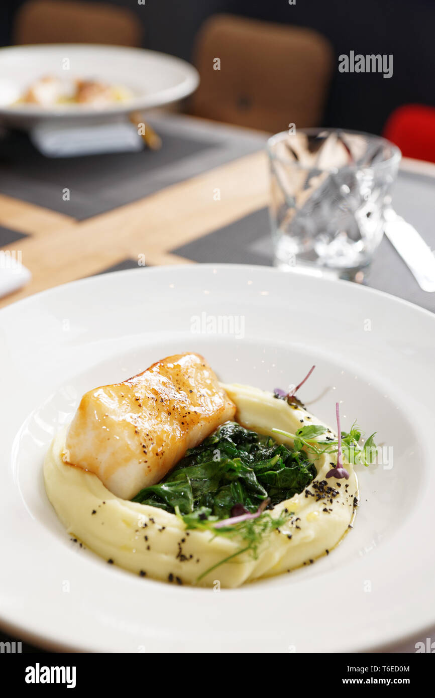 Fried seabass or cod fillet with potato mash and spinach Stock Photo ...
