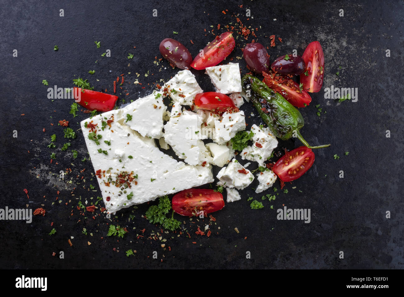 Traditional Greek Feta with Vegetable as top view on an old rusty metal ...