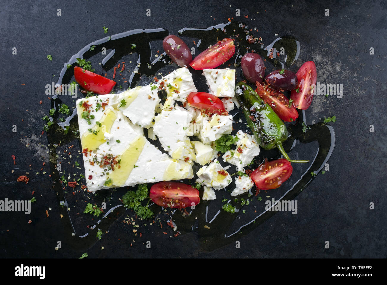 Traditional Greek Feta with Vegetable as top view on an old rusty metal ...