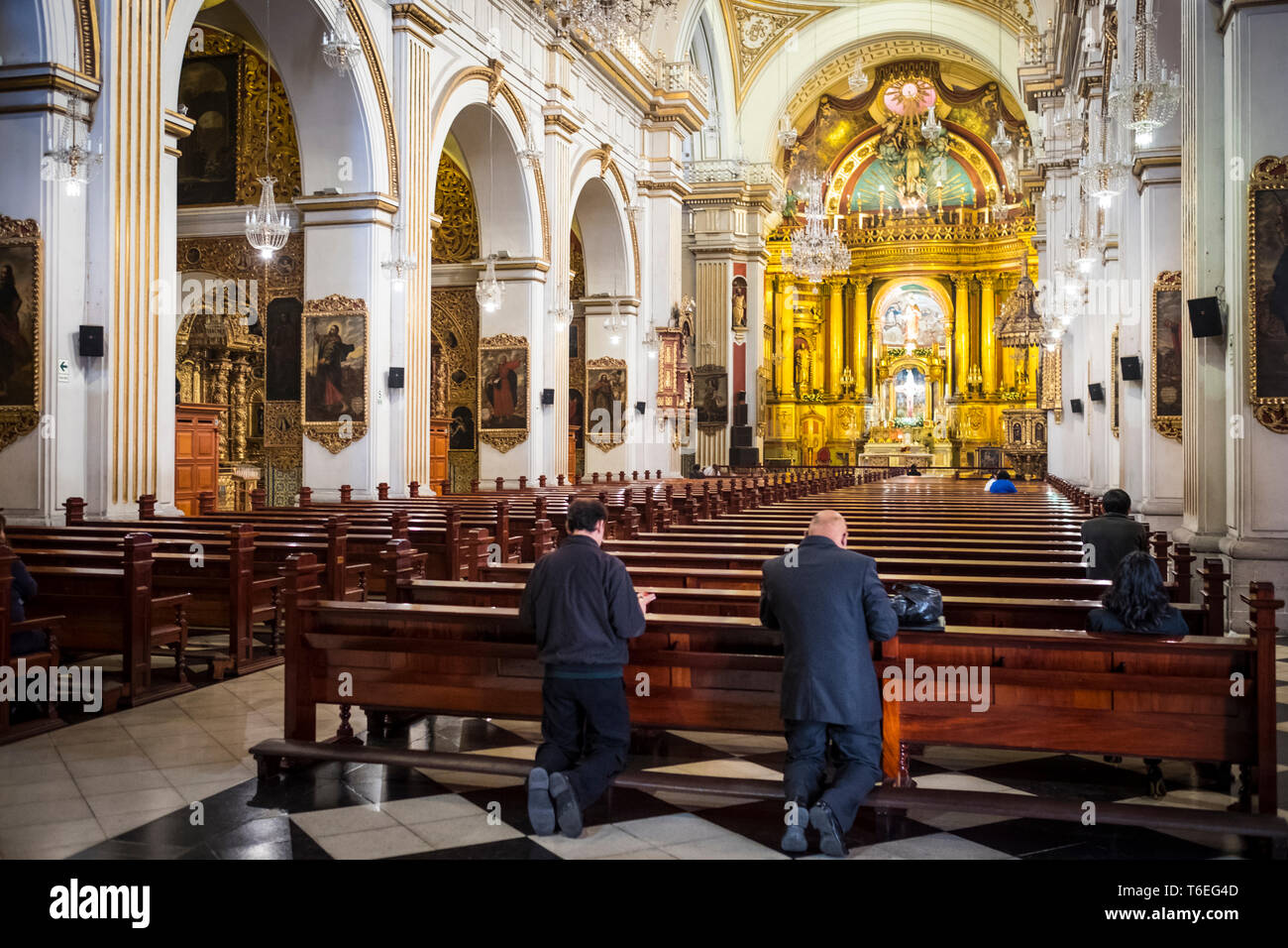 Kneeling men praying inside the Basilica Cathedral of Lima, Peru Stock ...
