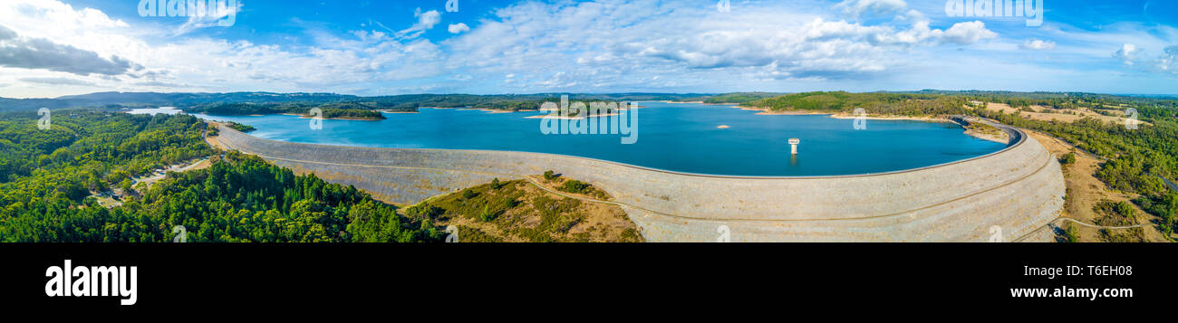 Wide aerial panorama of Cardinia Reservoir lake and dam wall surrounded ...