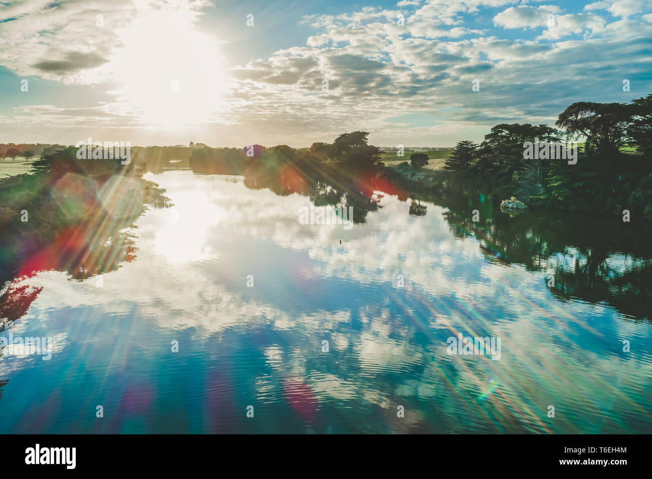 Aerial view of sunset over river with sun flare Stock Photo - Alamy