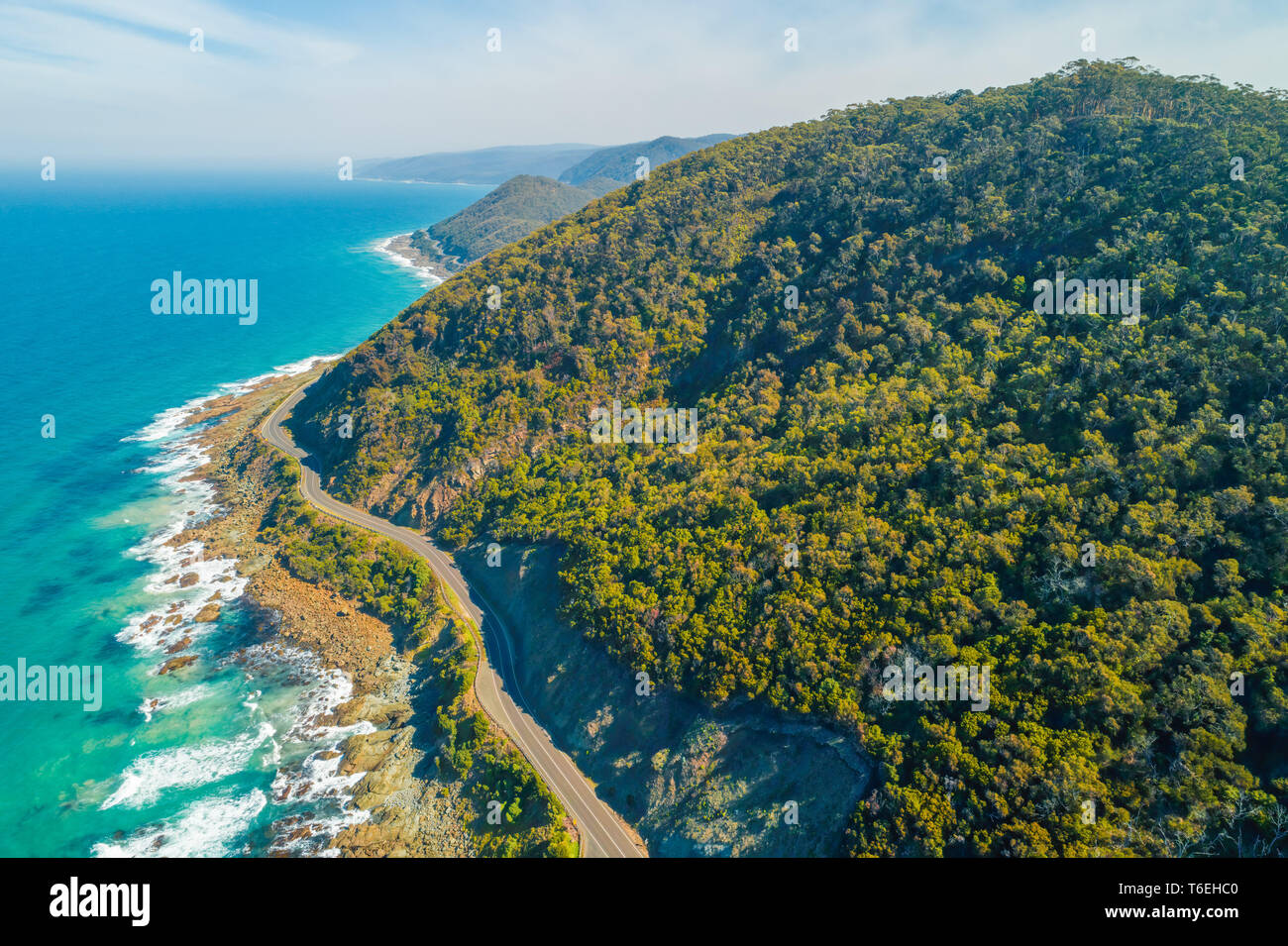 Great Ocean Road passing along scenic coastline - aerial landscape ...