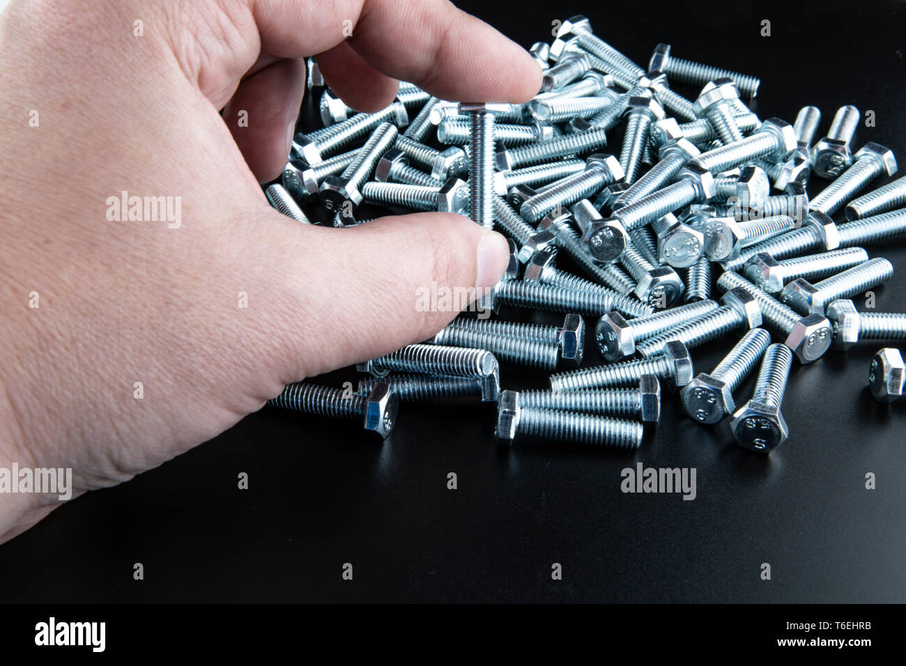 Hands holding nuts bolts hi-res stock photography and images - Alamy