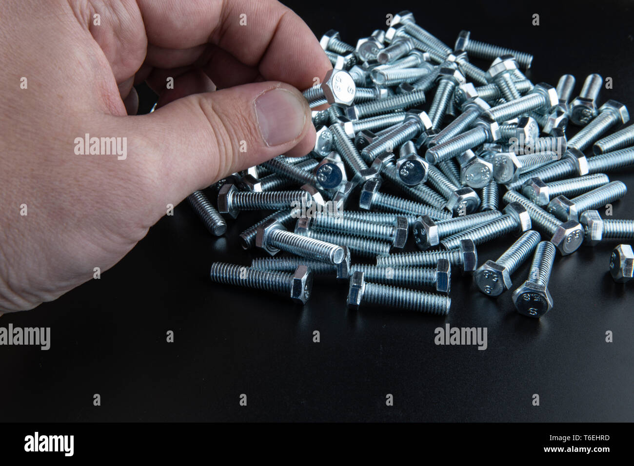 Hands holding nuts bolts hi-res stock photography and images - Alamy
