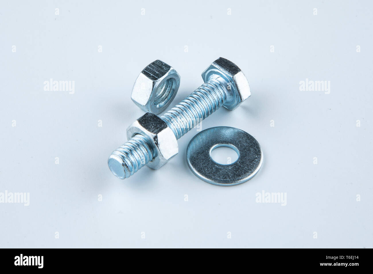 Nuts and bolts closeup on white background Stock Photo - Alamy