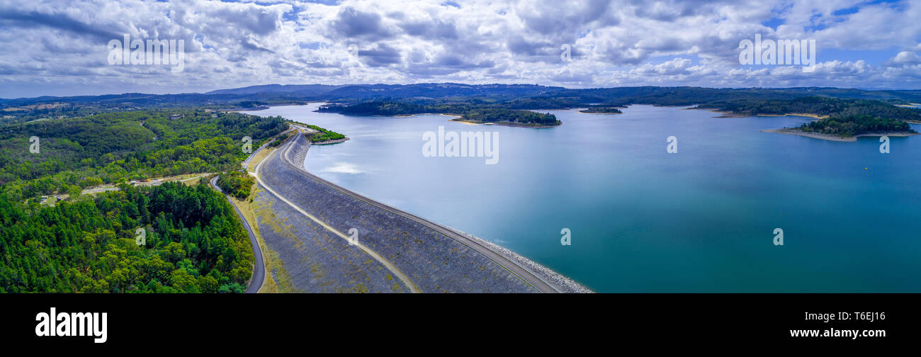 Wide aerial panorama of Cardinia Reservoir lake and dam wall surrounded ...