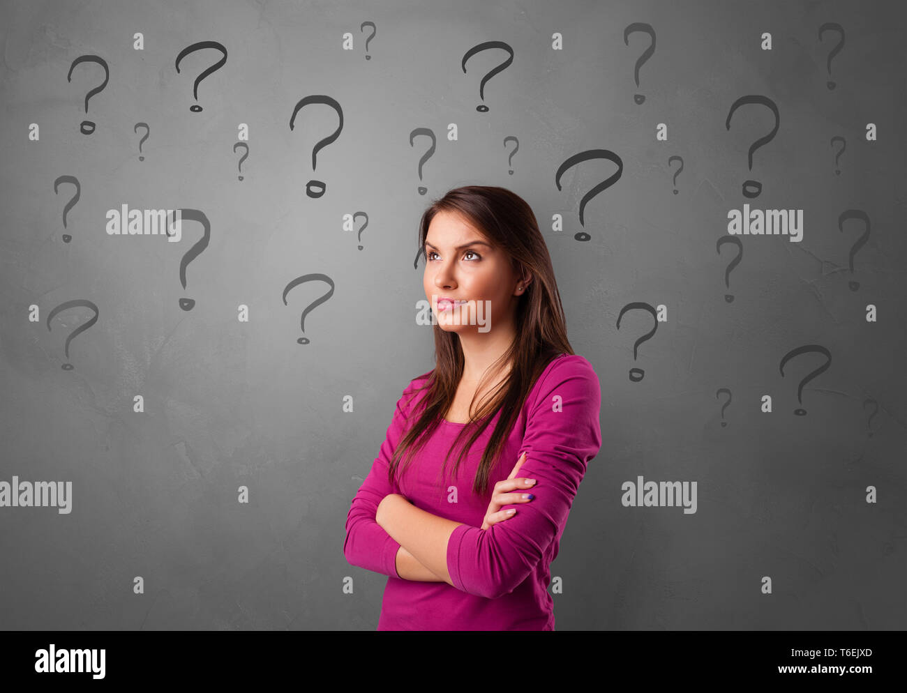 Person with question marks around face Stock Photo - Alamy