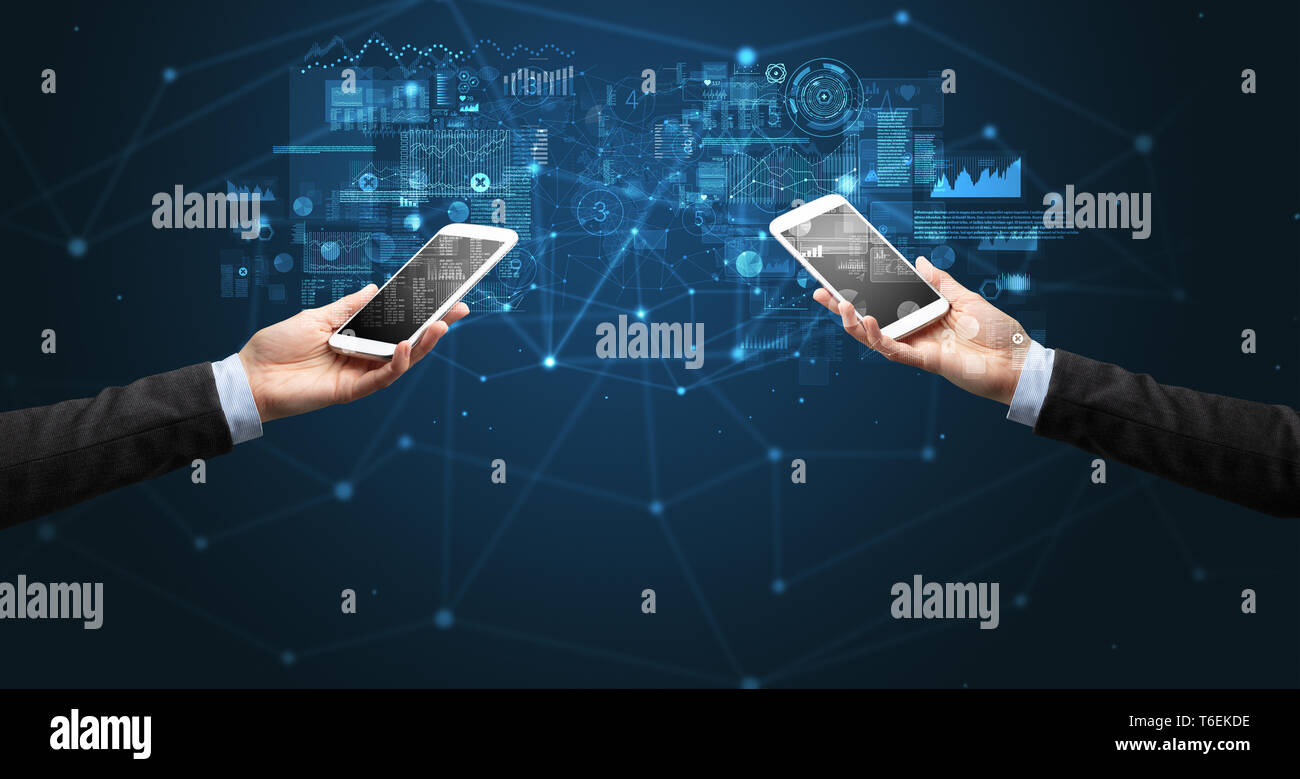 Close up of two hands holding smartphones to sync business data Stock ...