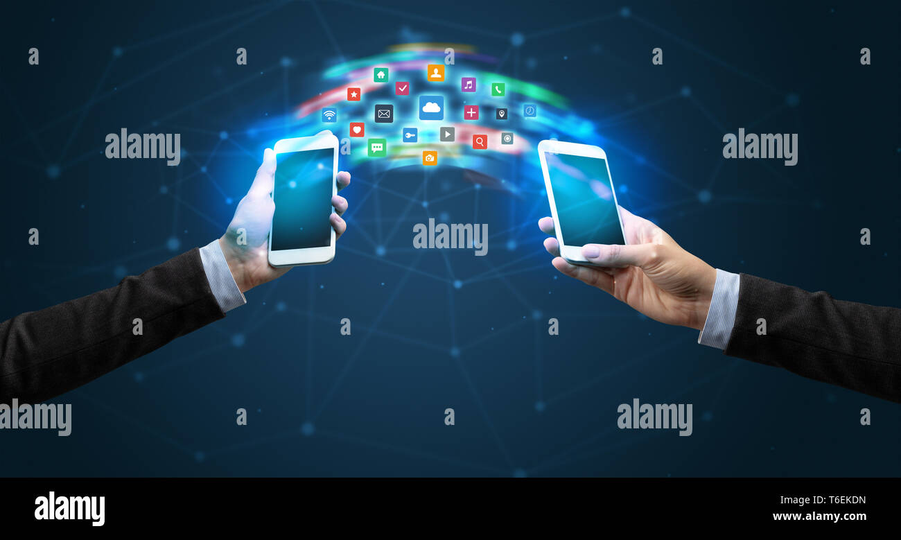 Two mobile phones syncing applications concept Stock Photo - Alamy