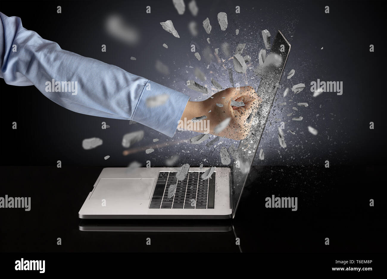 Strong male hand breaks laptop screen Stock Photo - Alamy