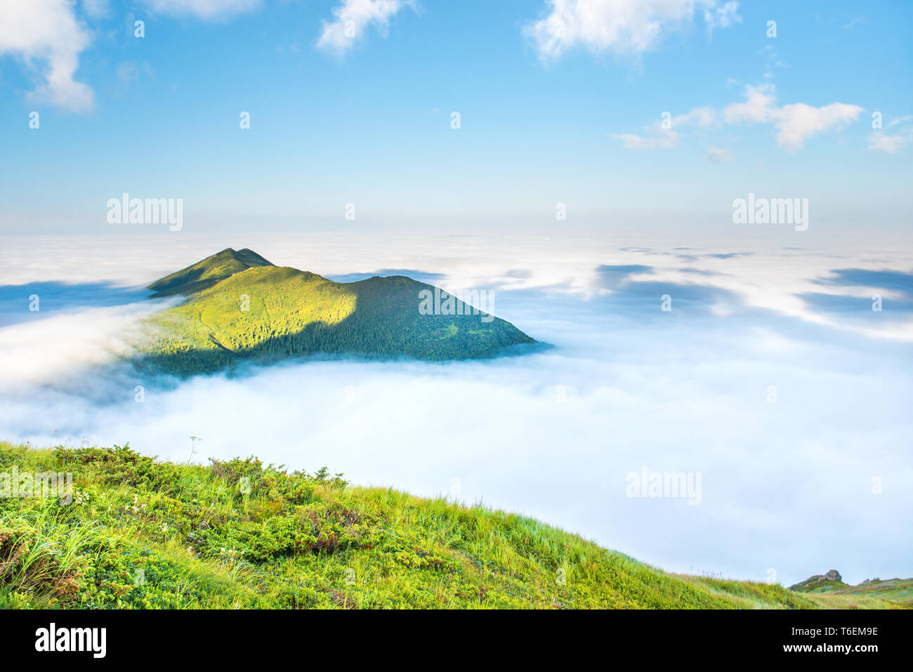 Green mountain in the clouds Stock Photo - Alamy