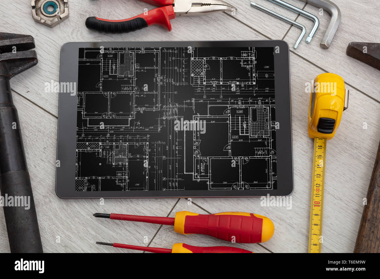 Tablet with construction tools and blueprint concept Stock Photo - Alamy