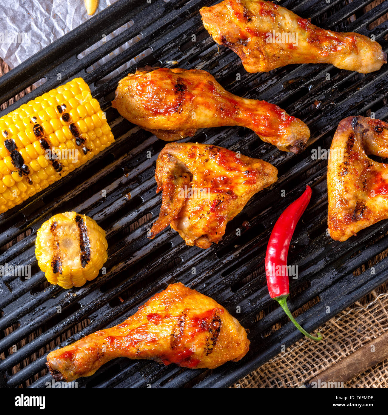 Rustic Grilled chicken wings,legs,and spicy corn Stock Photo - Alamy