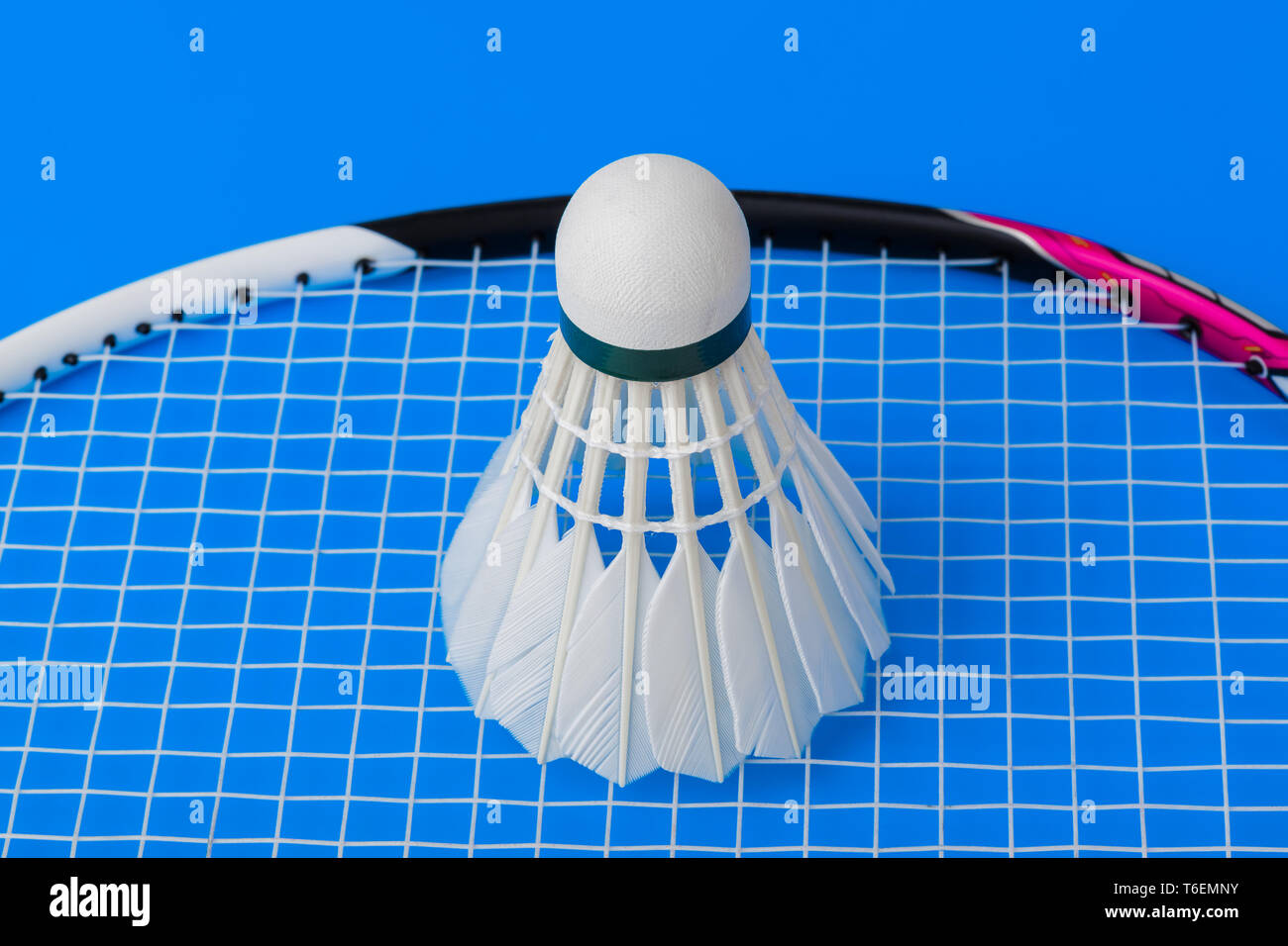 Badminton shuttlecock and racket on blue background Stock Photo - Alamy