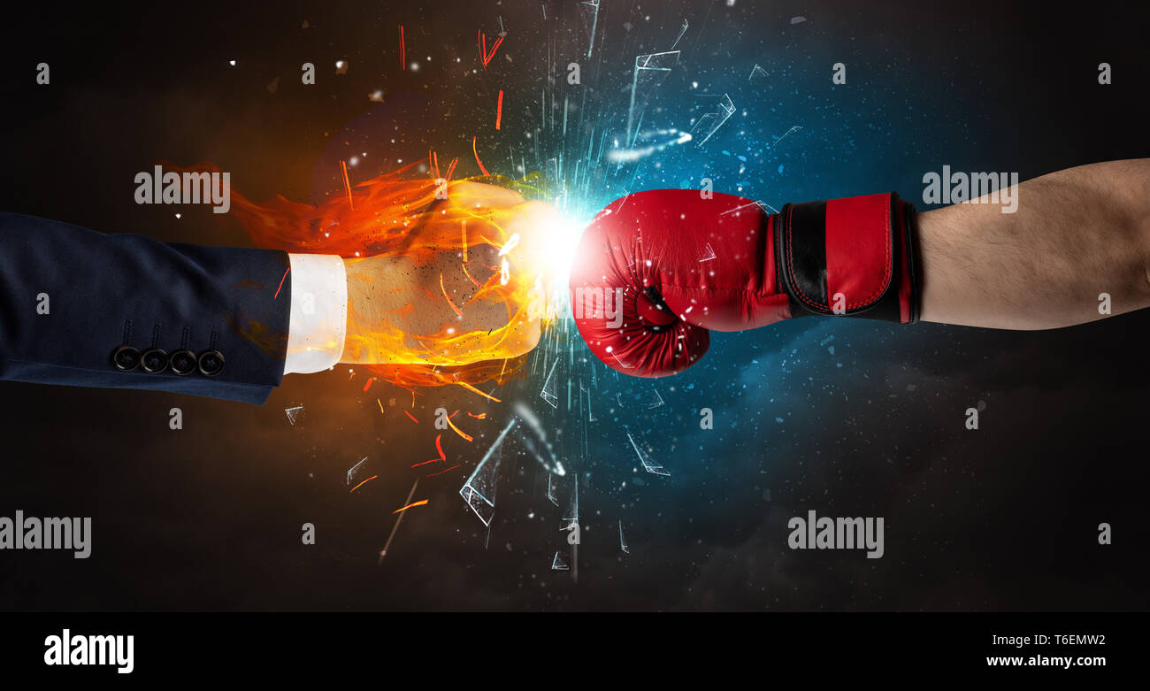 Two hands fighting and breaking glass into small pieces with fire and ...