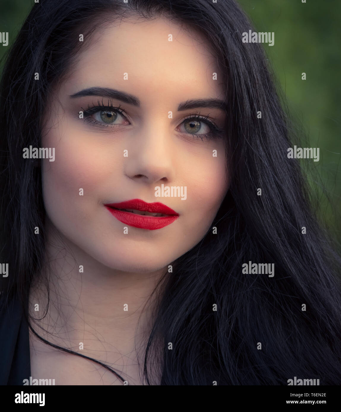 Attractive dark haired young woman wearing make up Stock Photo - Alamy