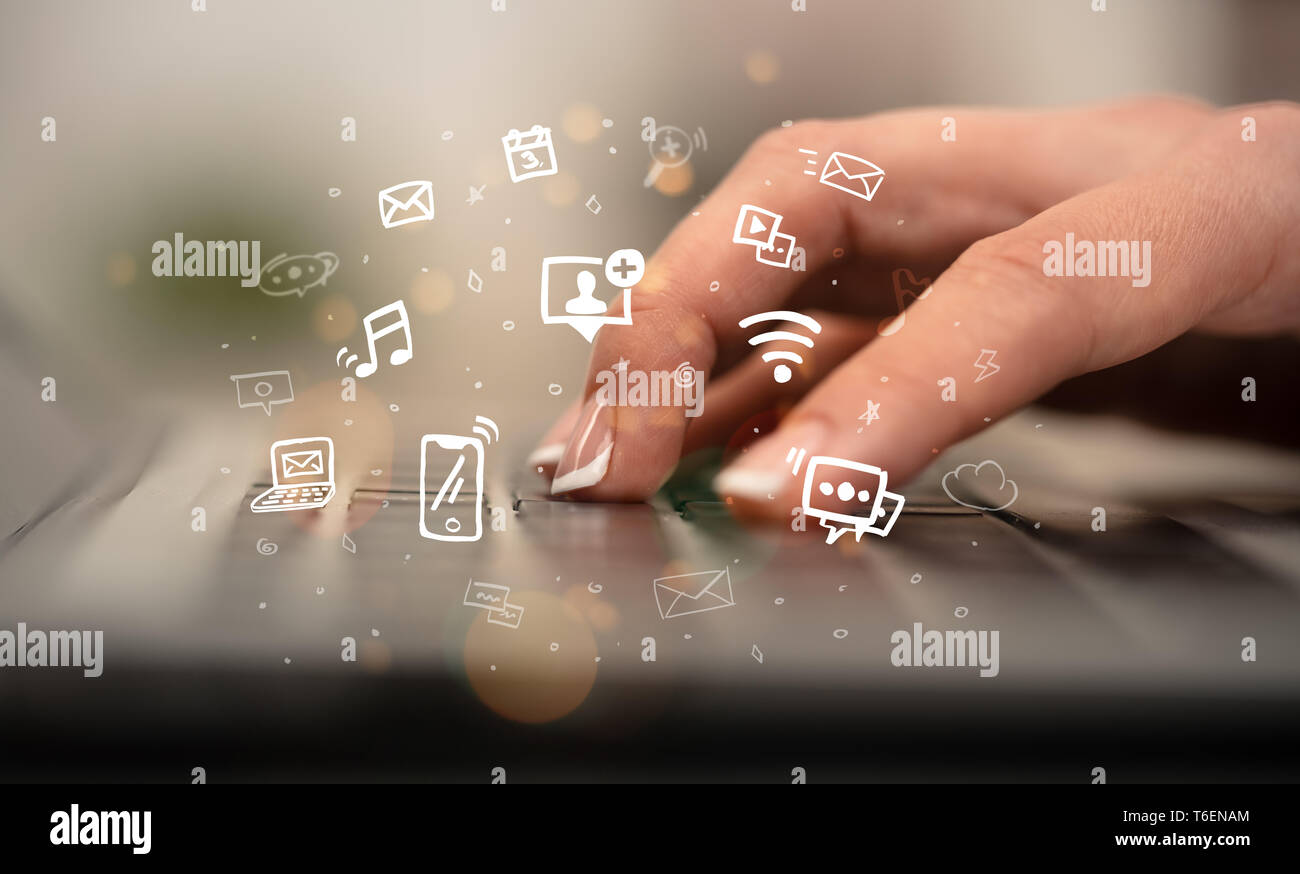 Business woman hand typing on keyboard with drawn application icons ...