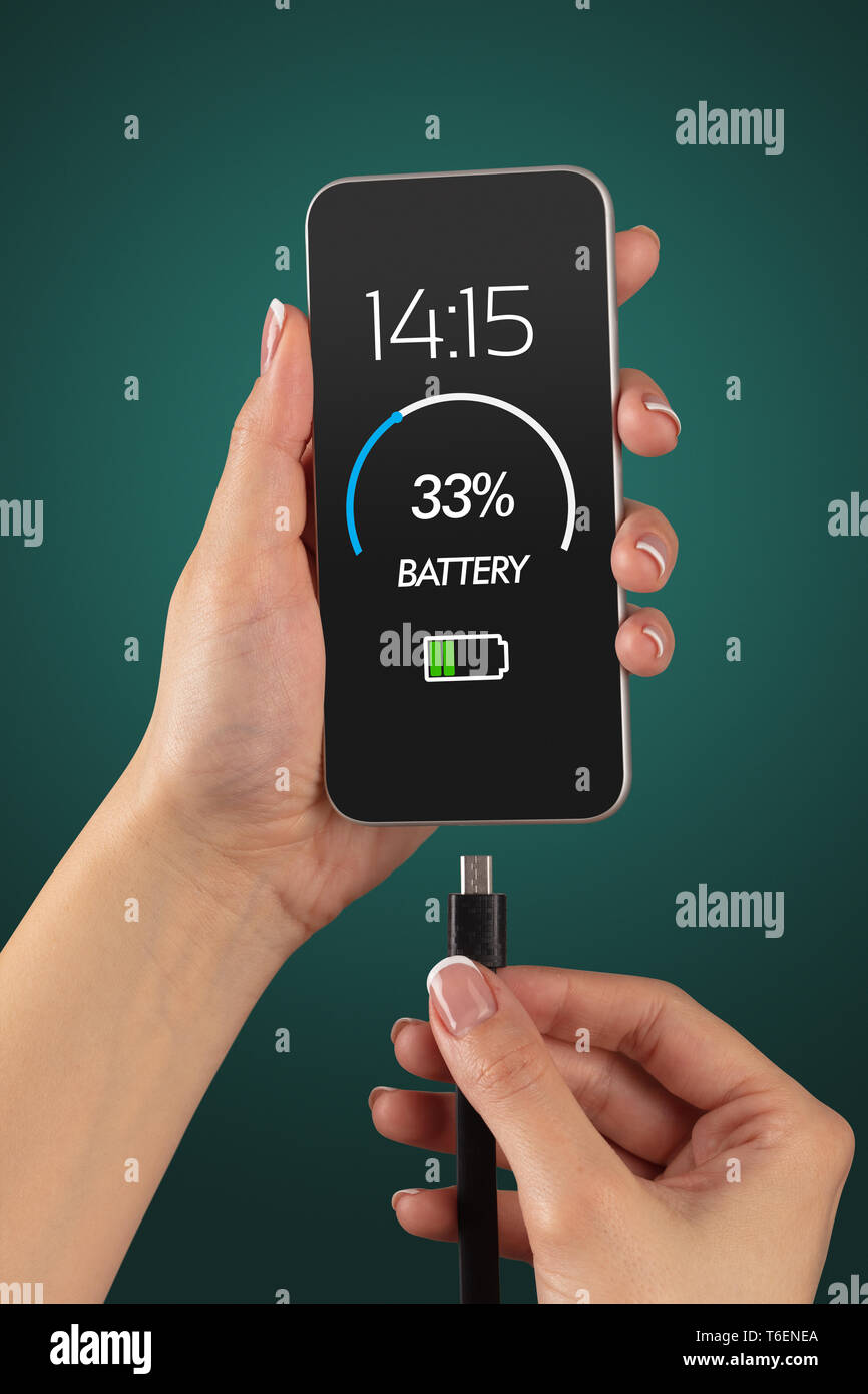 Elegant hand charging cellphone with low battery Stock Photo - Alamy