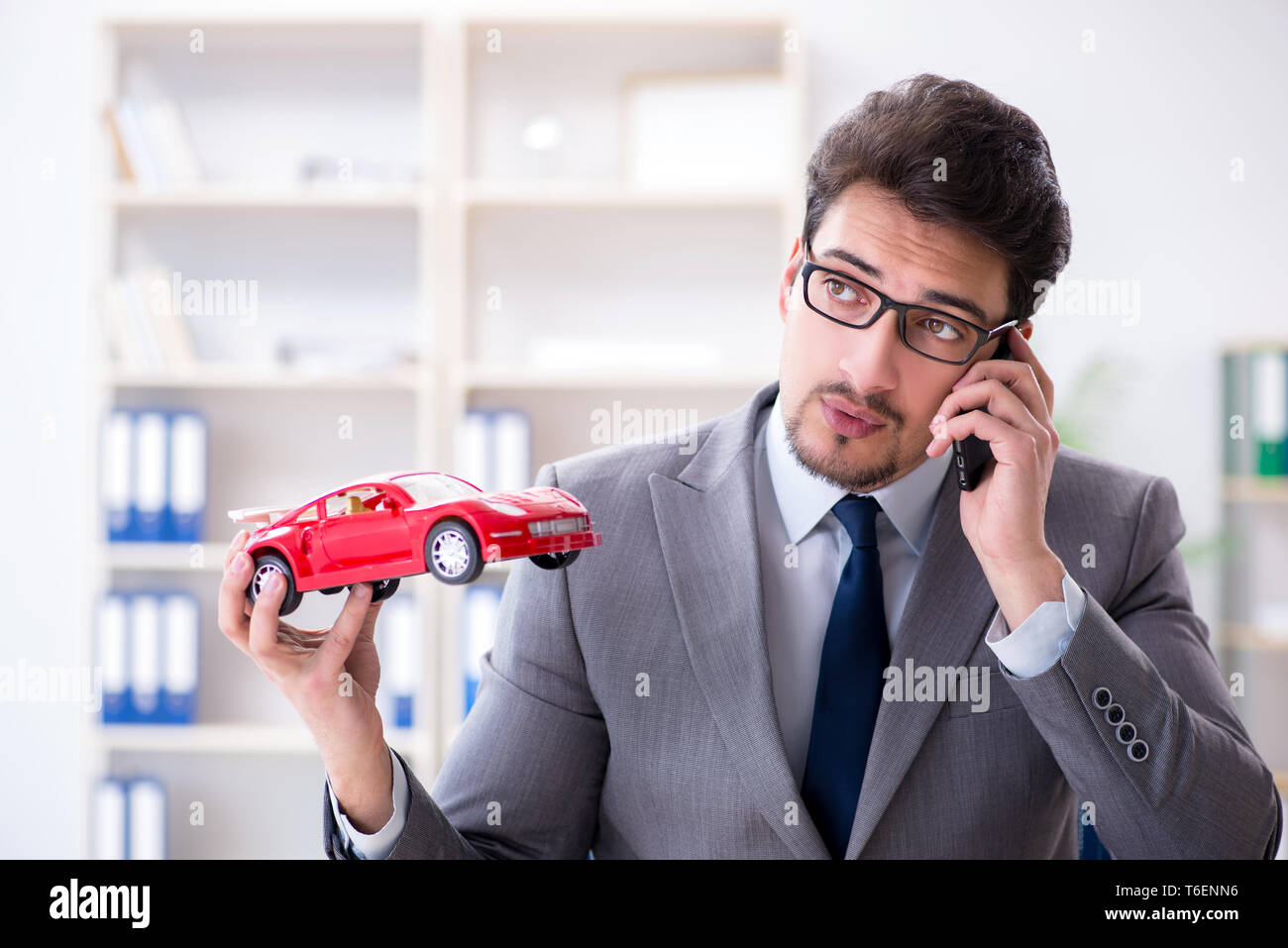 Agent offering car motor insurance Stock Photo - Alamy