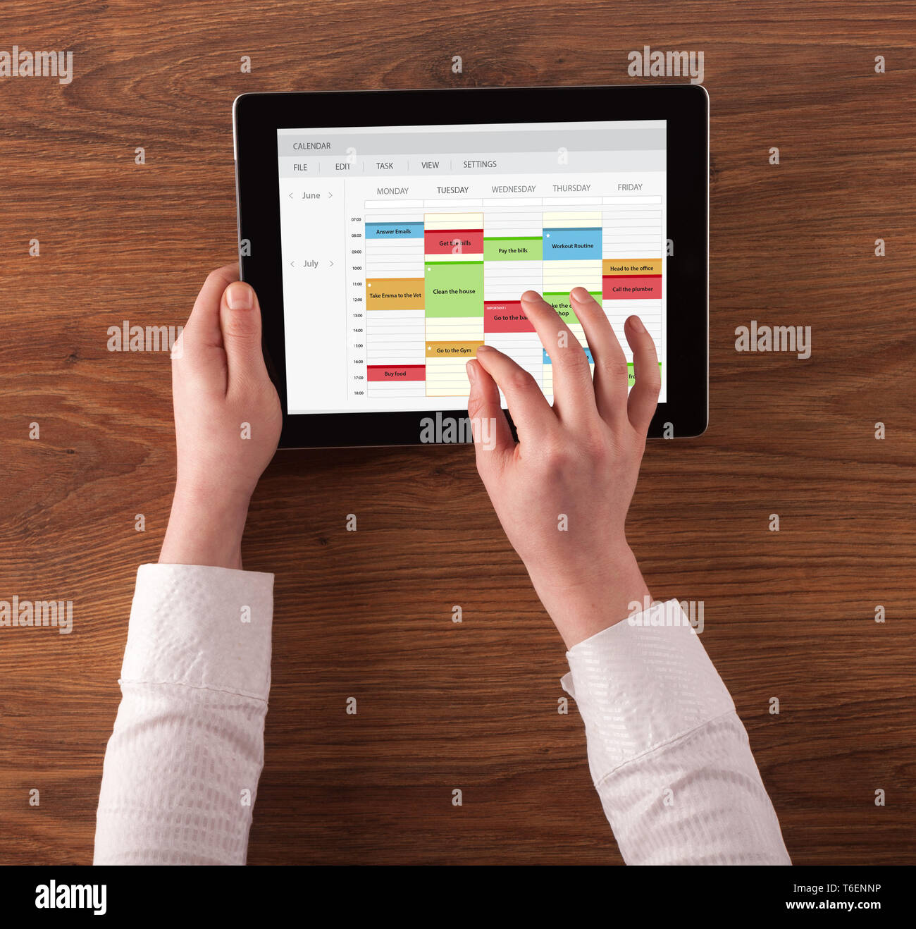 Hand holding tablet with timetable and calendar concept Stock Photo - Alamy