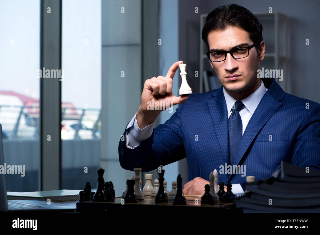 Businessman playing chess in strategy concept Stock Photo - Alamy