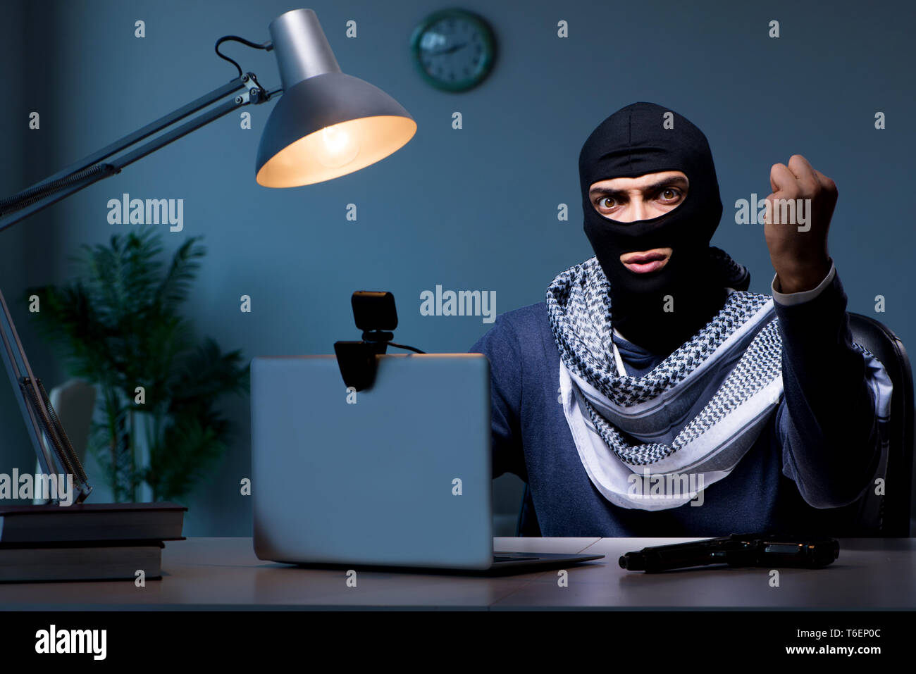 Hacker wearing balaclava mask hacking computer Stock Photo - Alamy