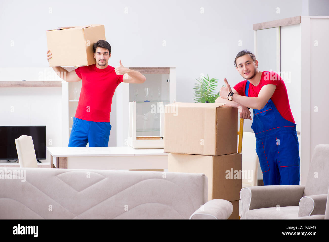 Two contractor employees moving personal belongings Stock Photo - Alamy