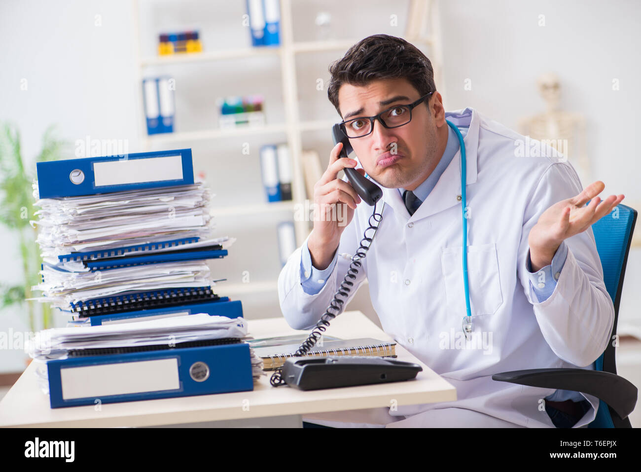 Busy doctor with too much work in hospital Stock Photo - Alamy