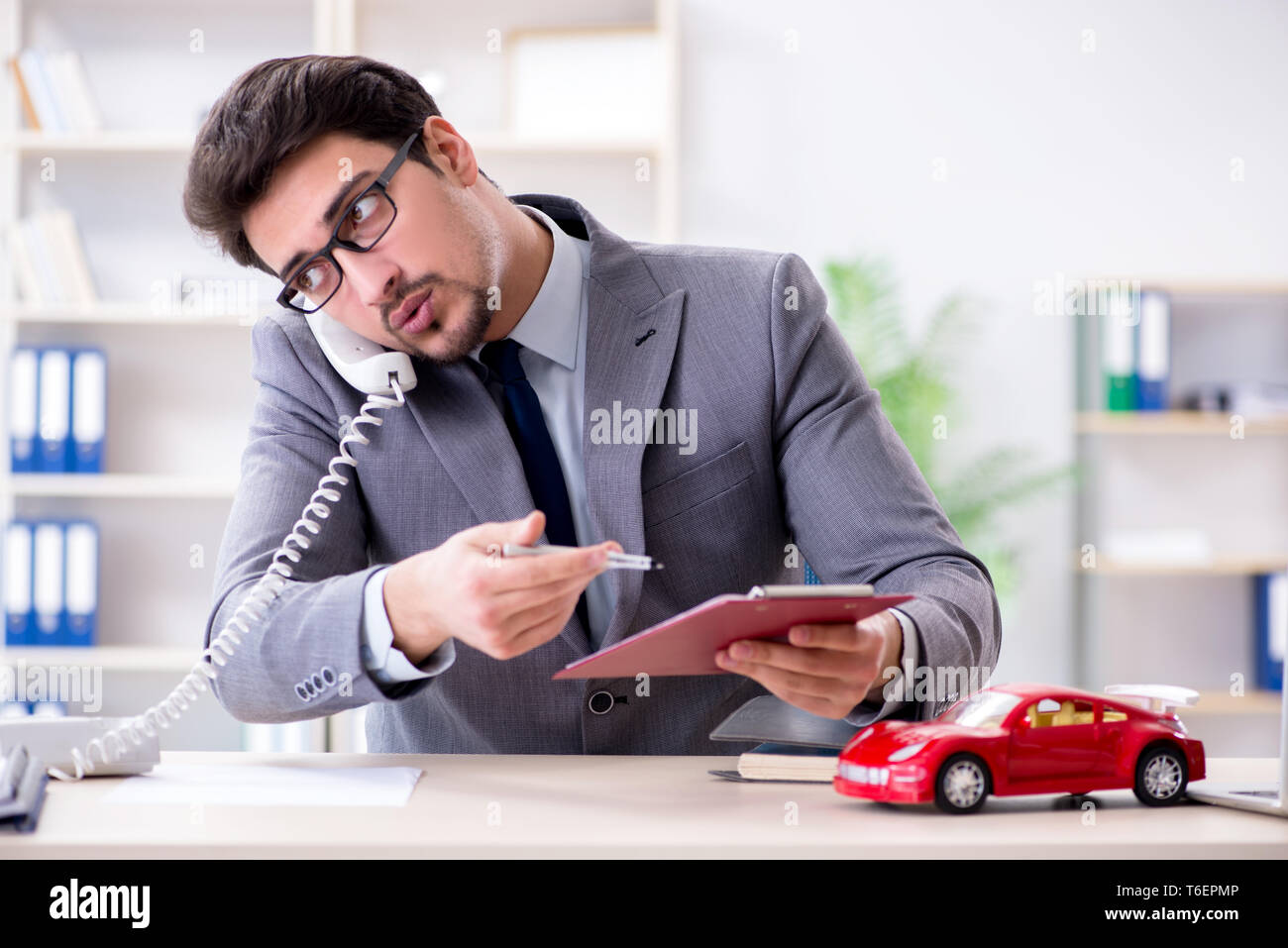 Agent offering car motor insurance Stock Photo - Alamy
