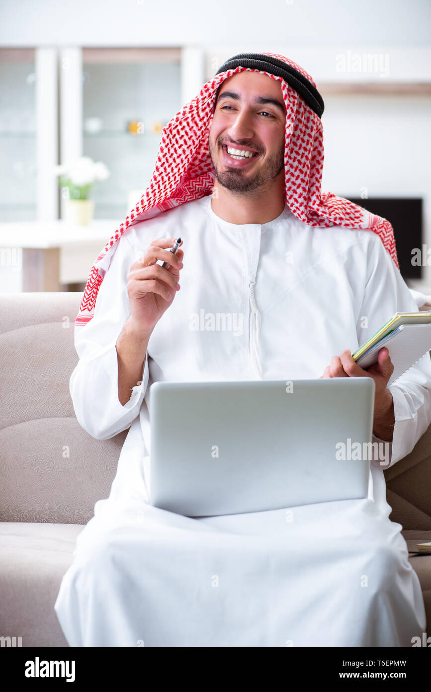 Arab man working at home on his work Stock Photo - Alamy