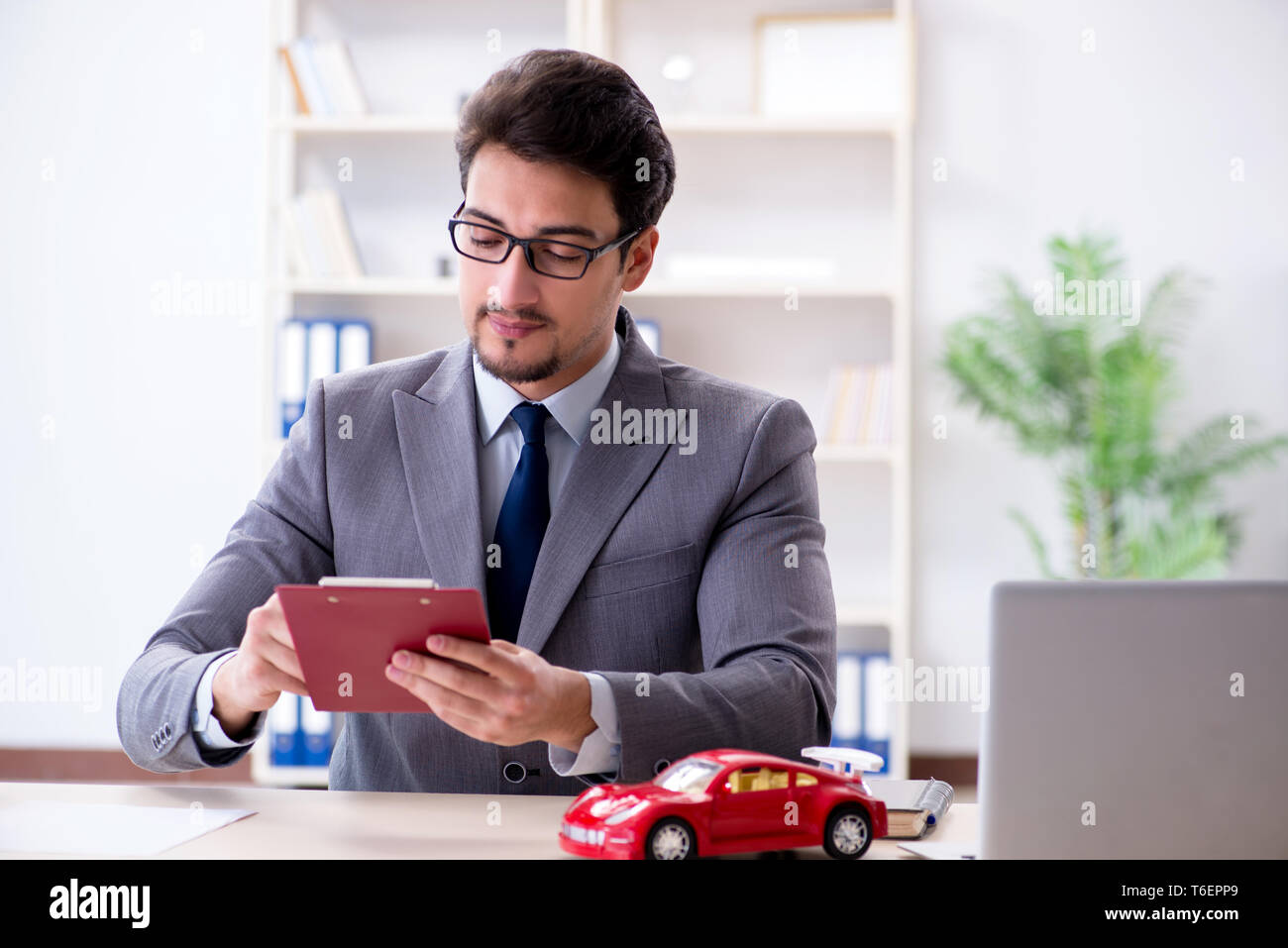 Agent offering car motor insurance Stock Photo - Alamy