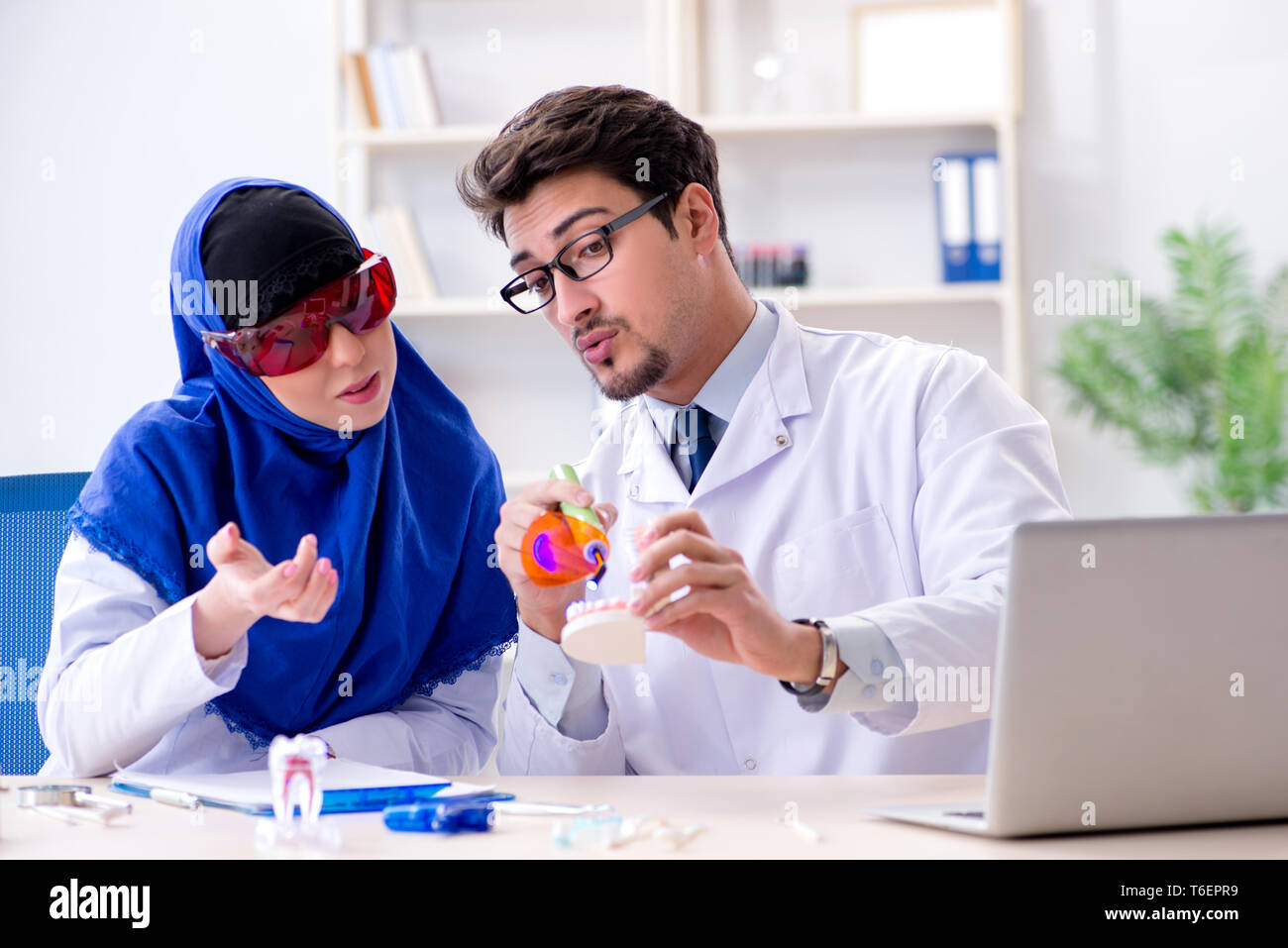 Dentist doctor and assistant working on new tooth implant Stock Photo ...