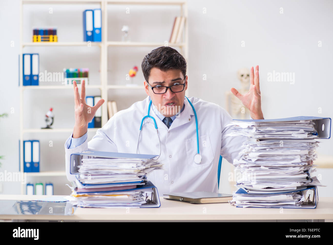 Busy doctor with too much work in hospital Stock Photo - Alamy