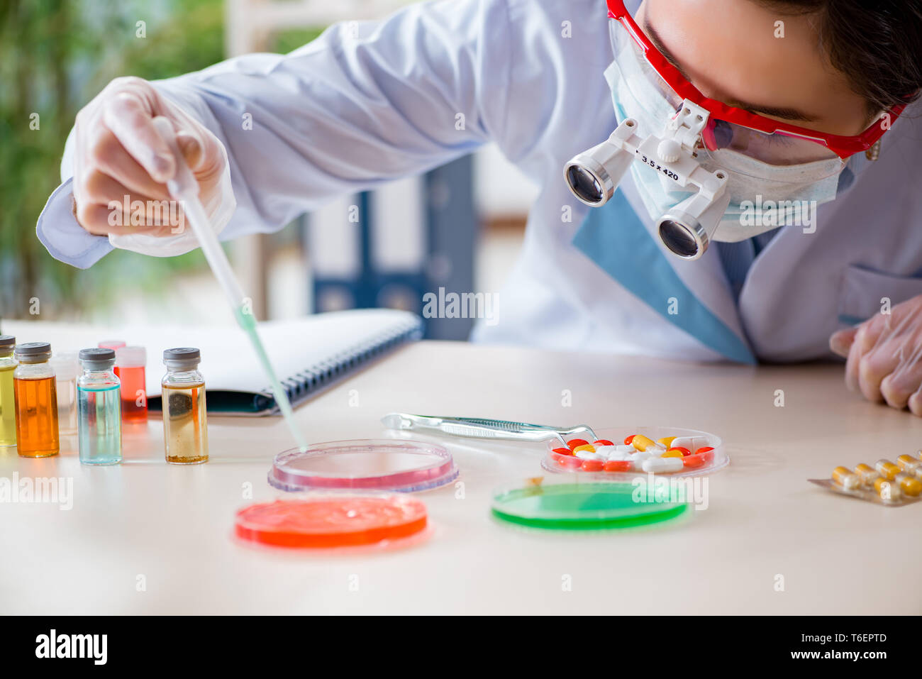 Lab assistant in drug synthesis concept Stock Photo - Alamy
