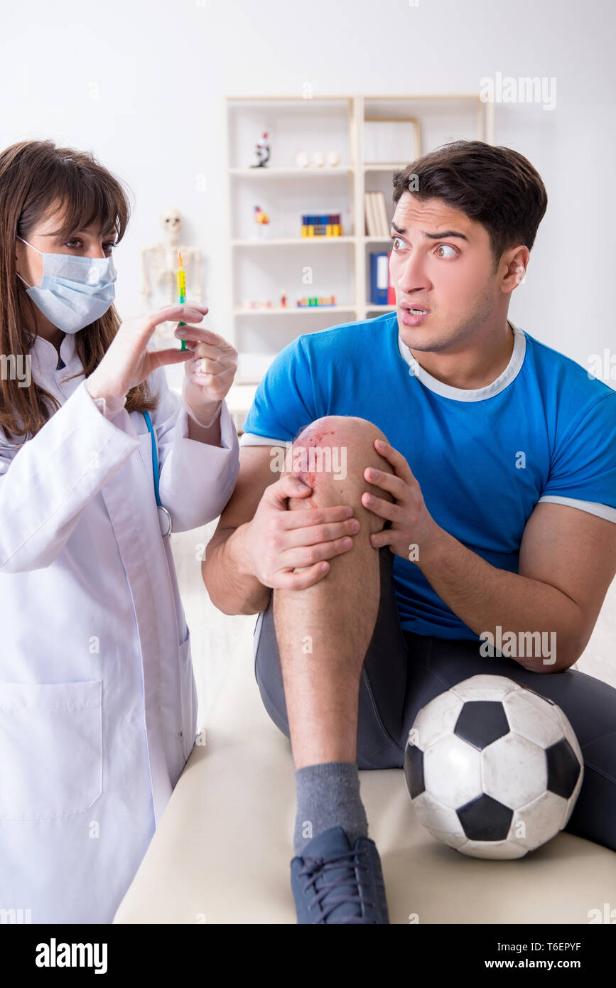Football soccer player visiting doctor after injury Stock Photo - Alamy
