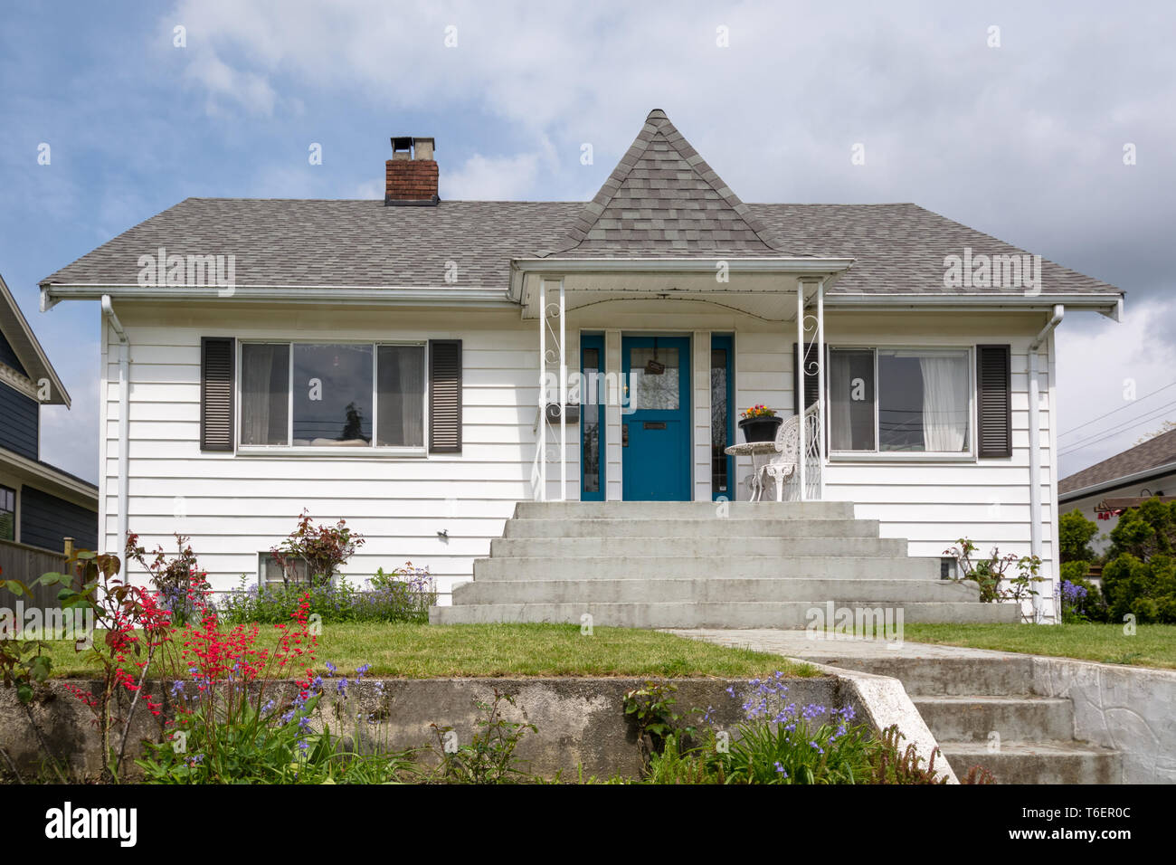 Modest family house on cloudy sky background Stock Photo - Alamy