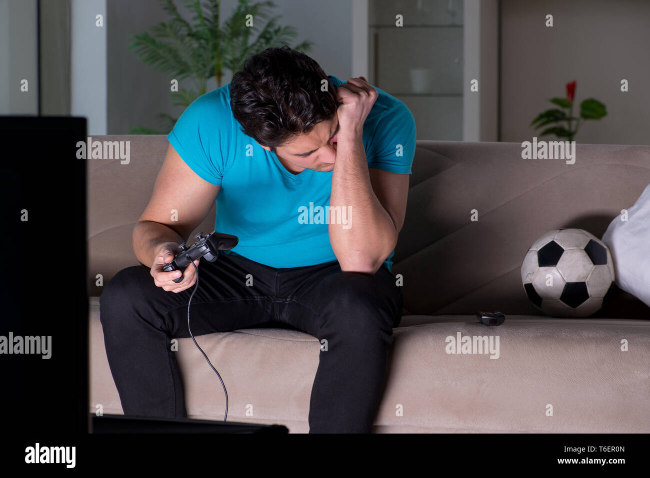 Young man playing computer games late at night Stock Photo - Alamy