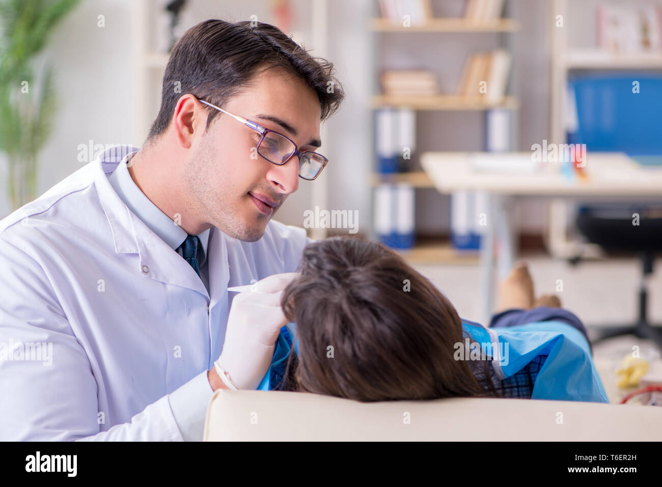 Patient visiting dentist for regular check-up and filling Stock Photo ...