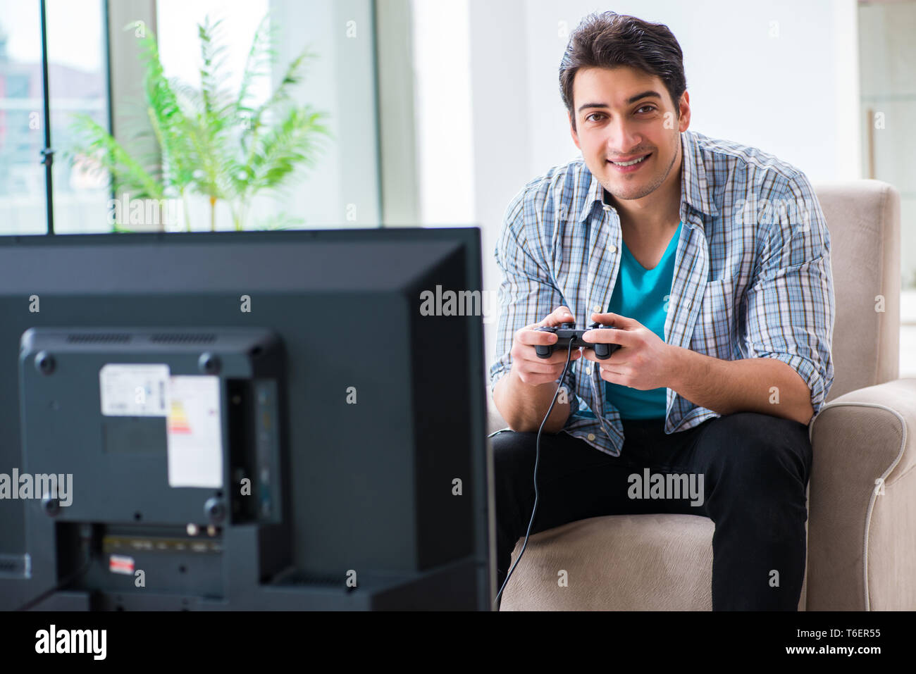 Playing racing videogame hi-res stock photography and images - Alamy