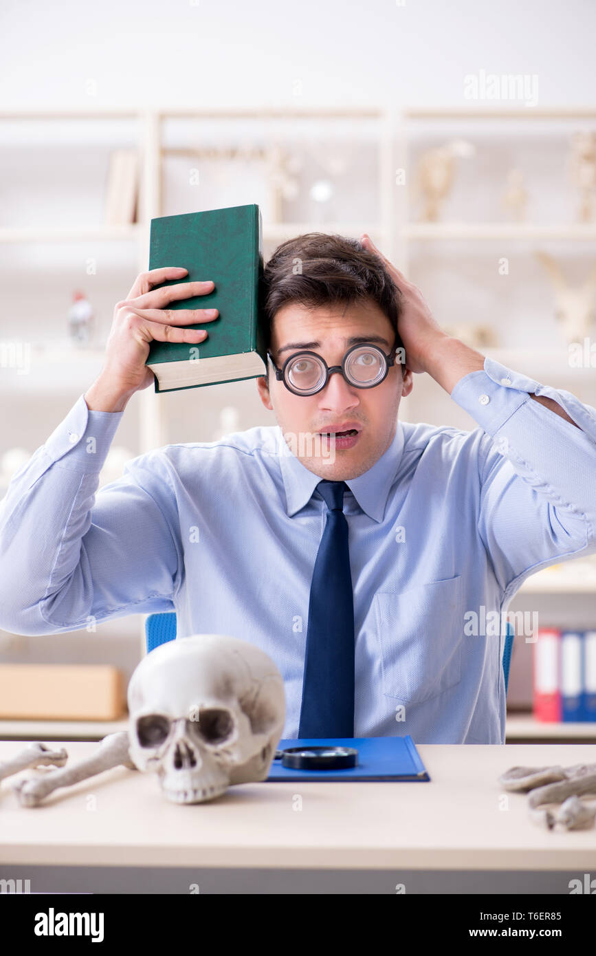 Funny crazy professor studying human skeleton Stock Photo - Alamy