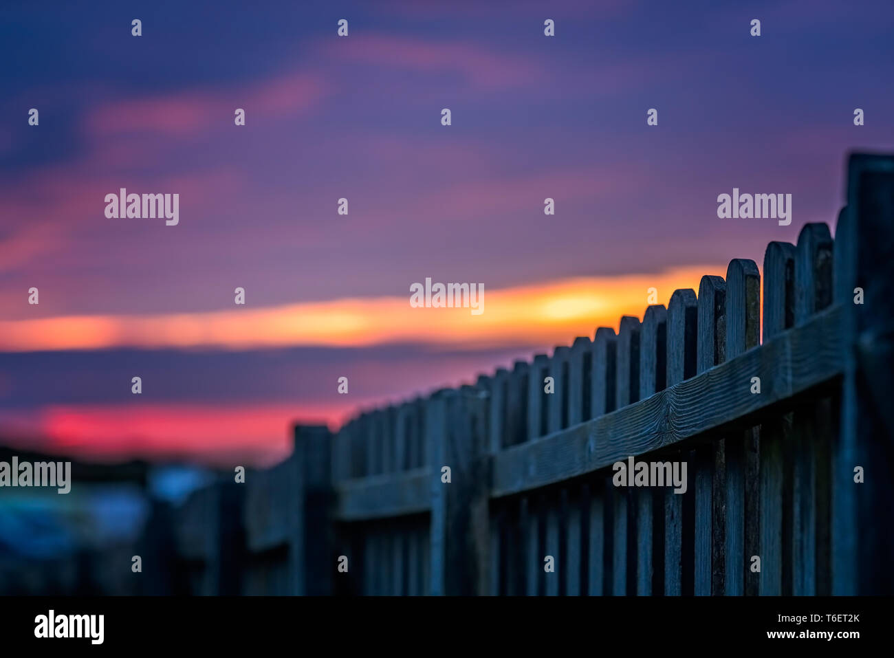 Wooden fence and sunset sky Stock Photo - Alamy